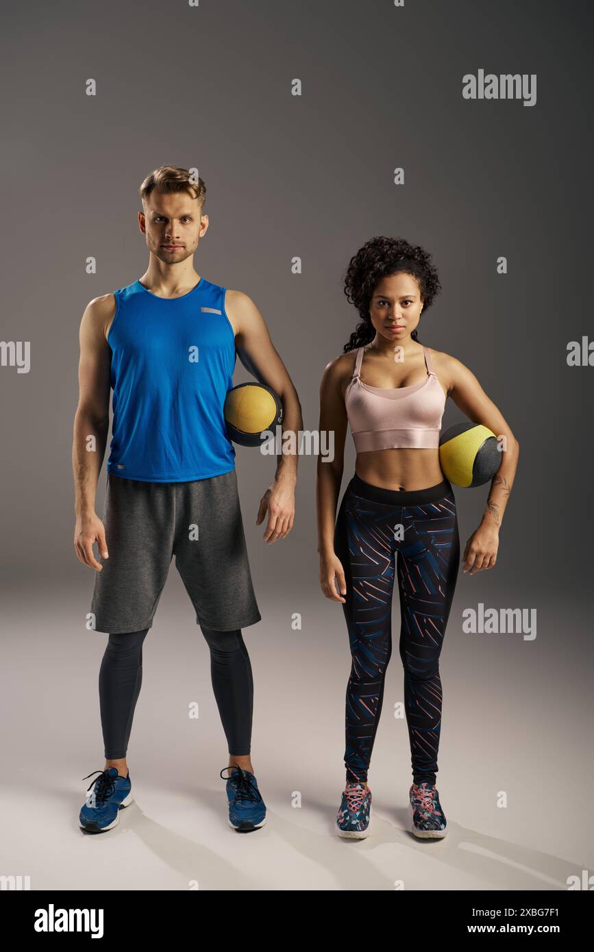 Young multicultural couple in active wear posing confidently for the ...