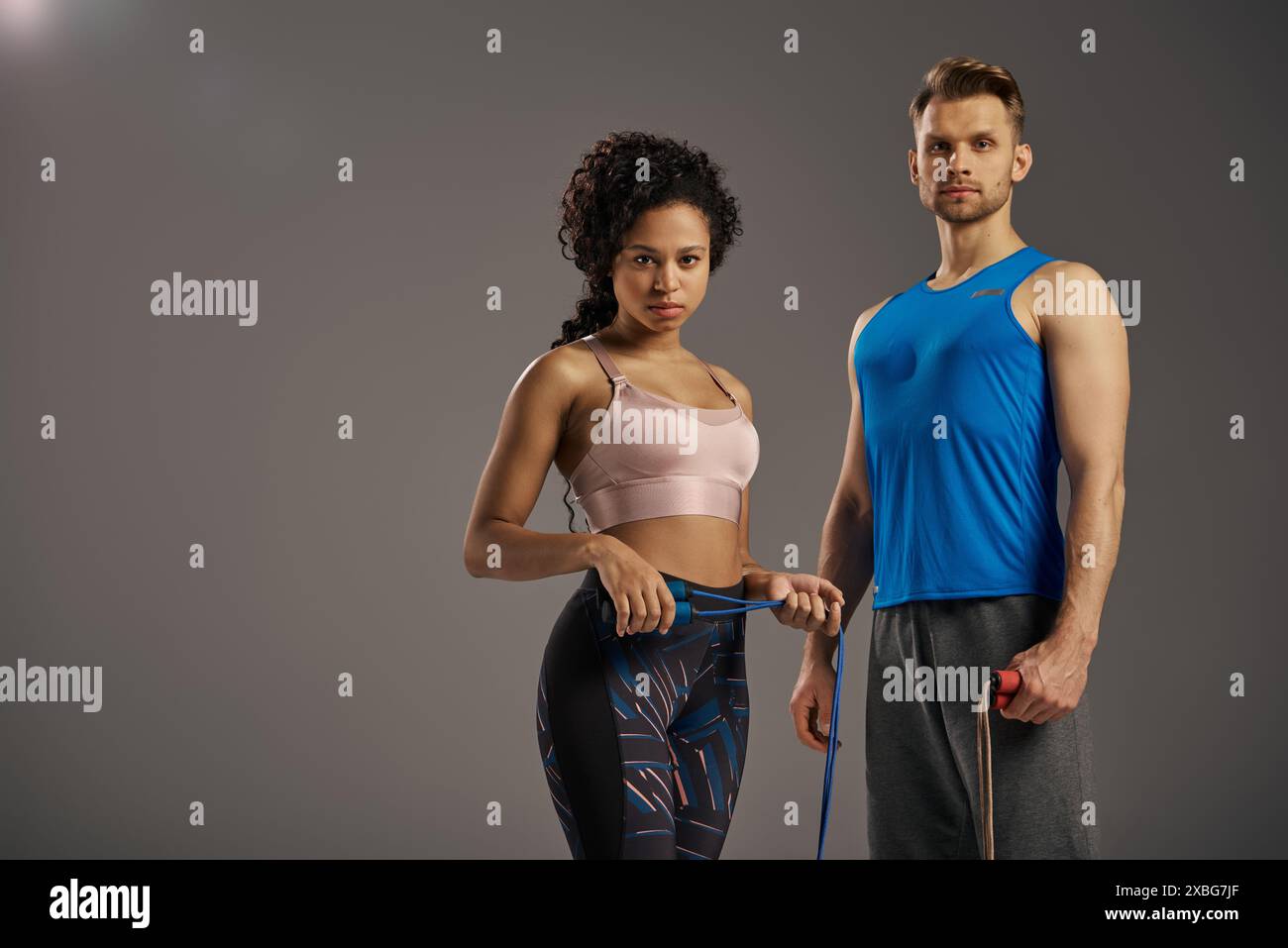 A multicultural couple in activewear poses for a fitness video ...