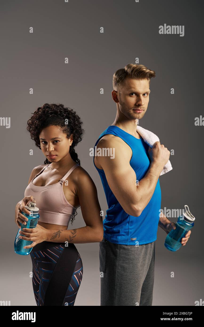 A young multicultural and fit couple in active wear striking a pose on ...