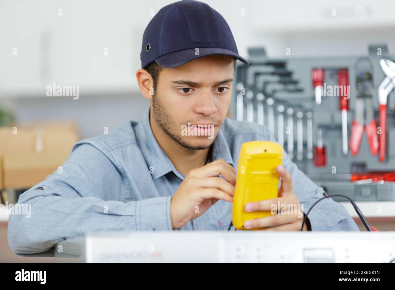 a worker calibrating a machine Stock Photo - Alamy