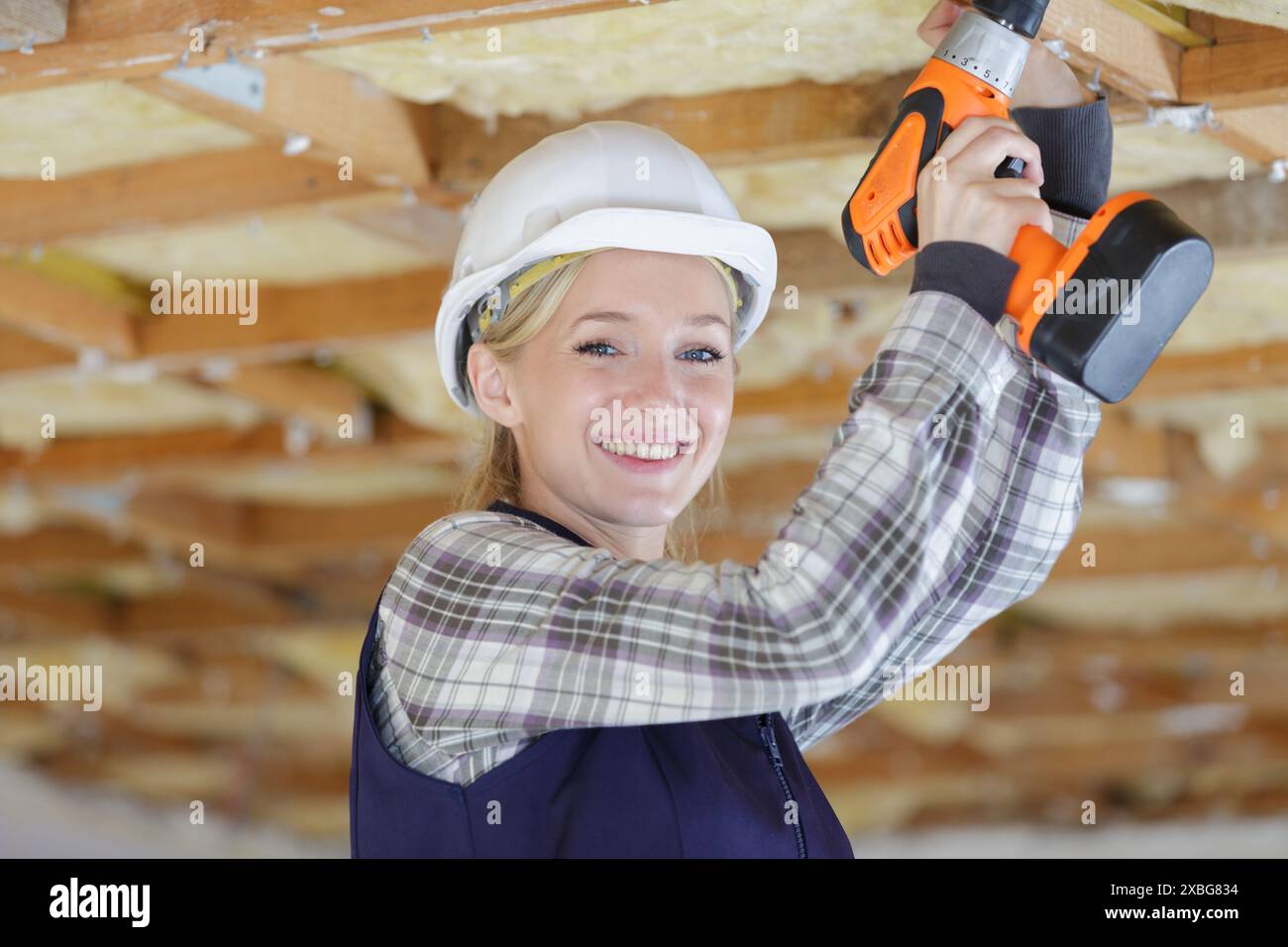 Female builder hard hat drill hi-res stock photography and images - Alamy