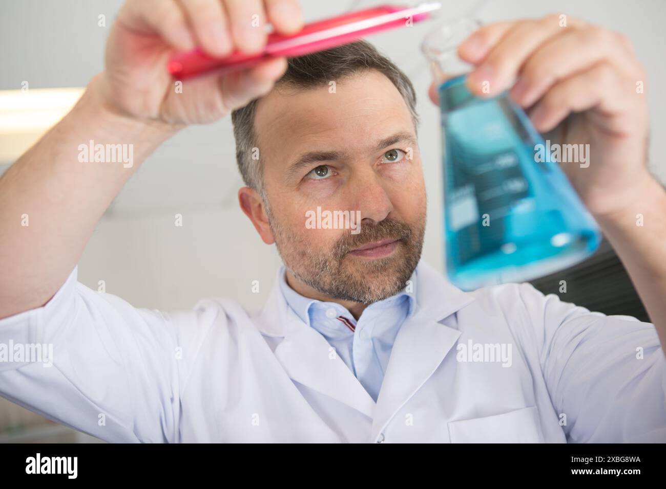 Scientist man pipetting liquid hi-res stock photography and images - Alamy