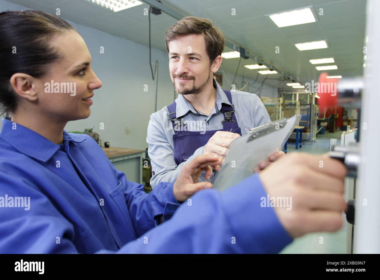 industrial man and woman engineer with clipboard in a factory Stock ...