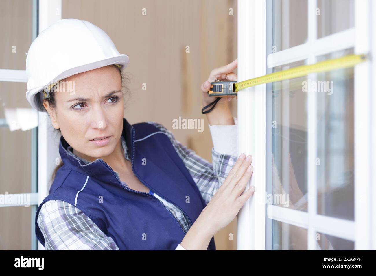 a woman measuring window sill Stock Photo - Alamy