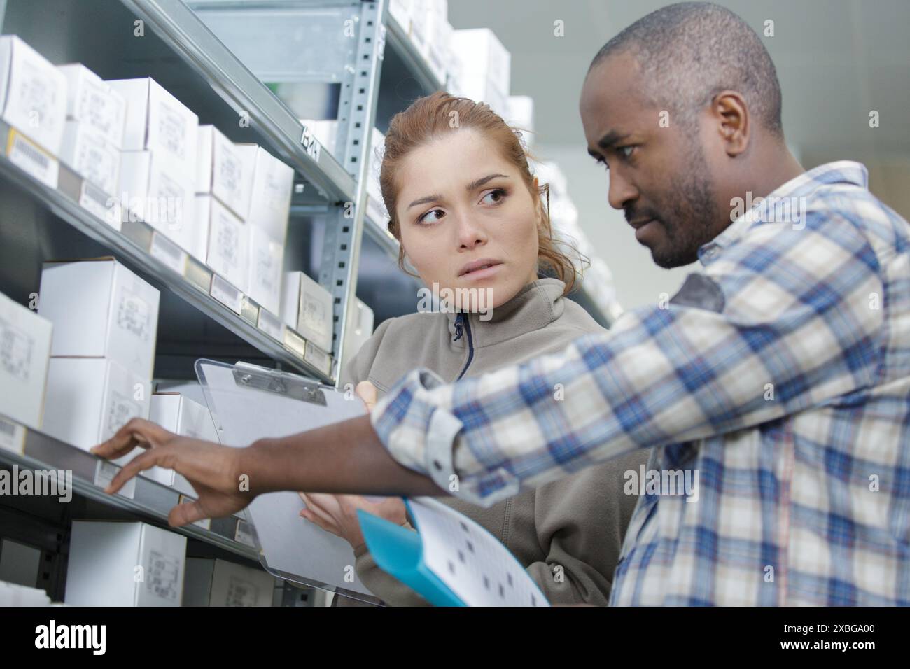 workers checking order list for collecting products in the warehouse ...