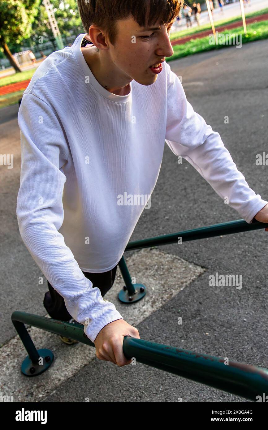 Young Man Performing Dips Exercise on Parallel Bars in Outdoor Park ...
