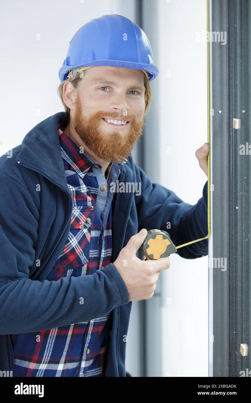 male worker using tape measure Stock Photo - Alamy