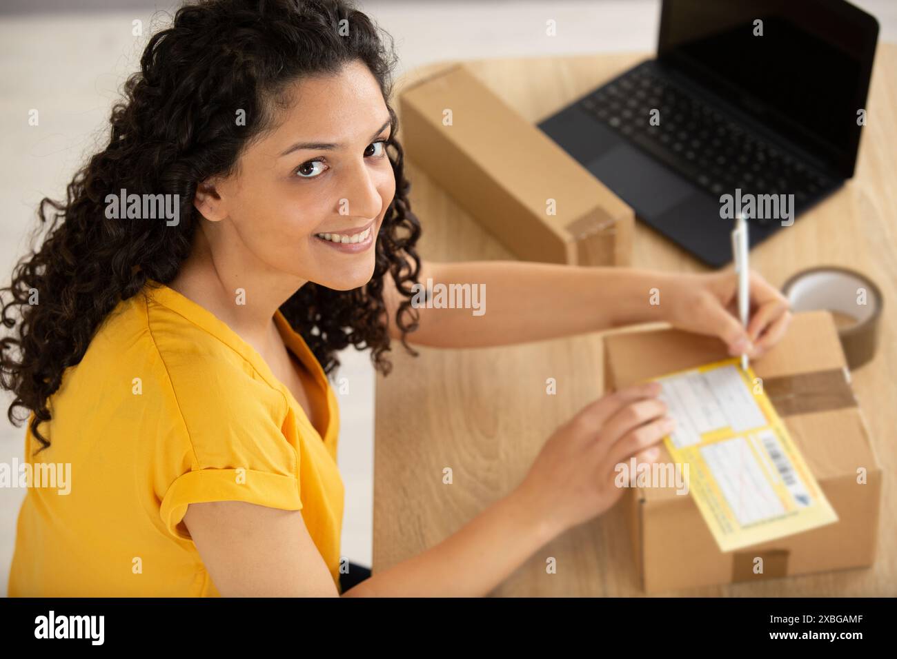 delivery mail shipping woman writing on box Stock Photo - Alamy