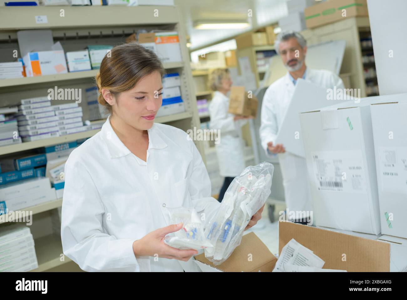 female harmacist holding medicines in pharmacy Stock Photo - Alamy