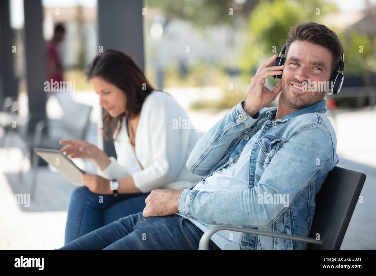 people using their phones while waiting bus Stock Photo - Alamy