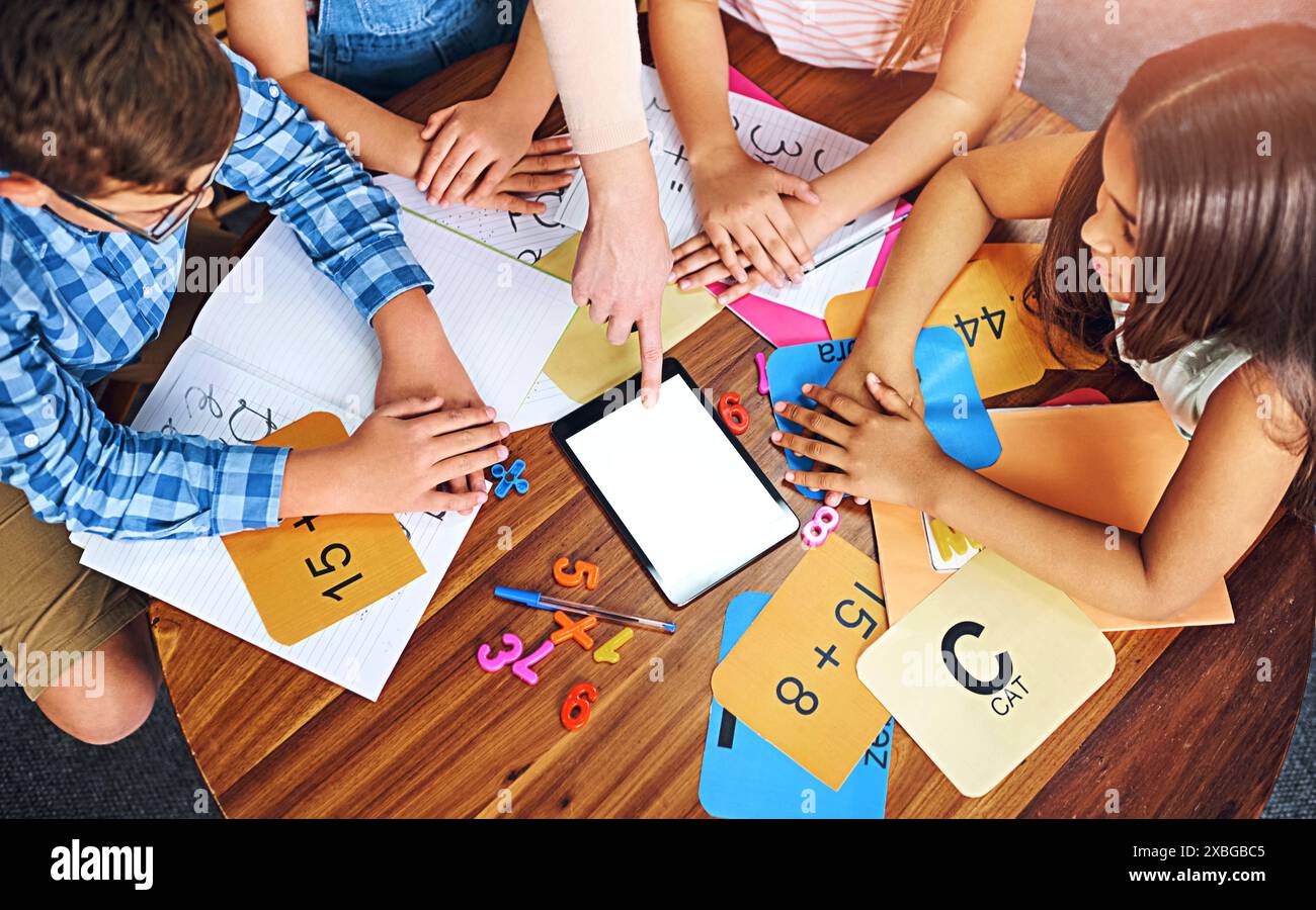 Children, teacher and tablet in classroom with group, mockup space and ...