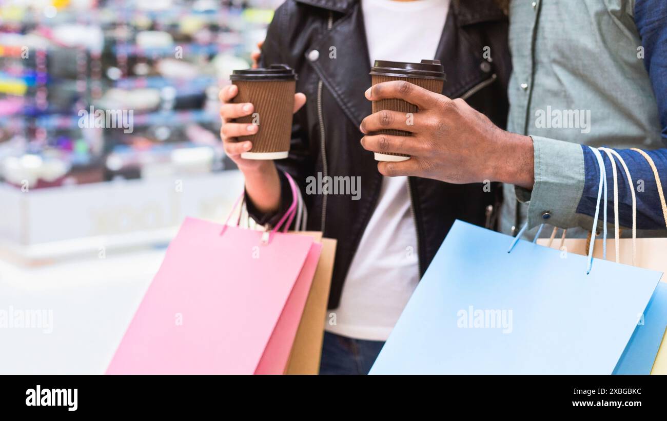 Two Friends Enjoying Coffee While Carrying Shopping Bags at Mall Stock ...