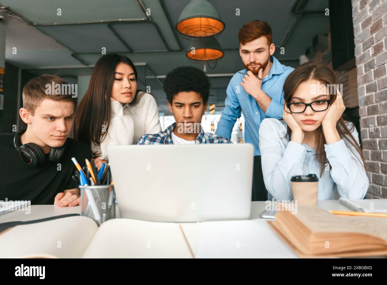 Group of Young Adults Engaged in Collaborative Work Stock Photo - Alamy