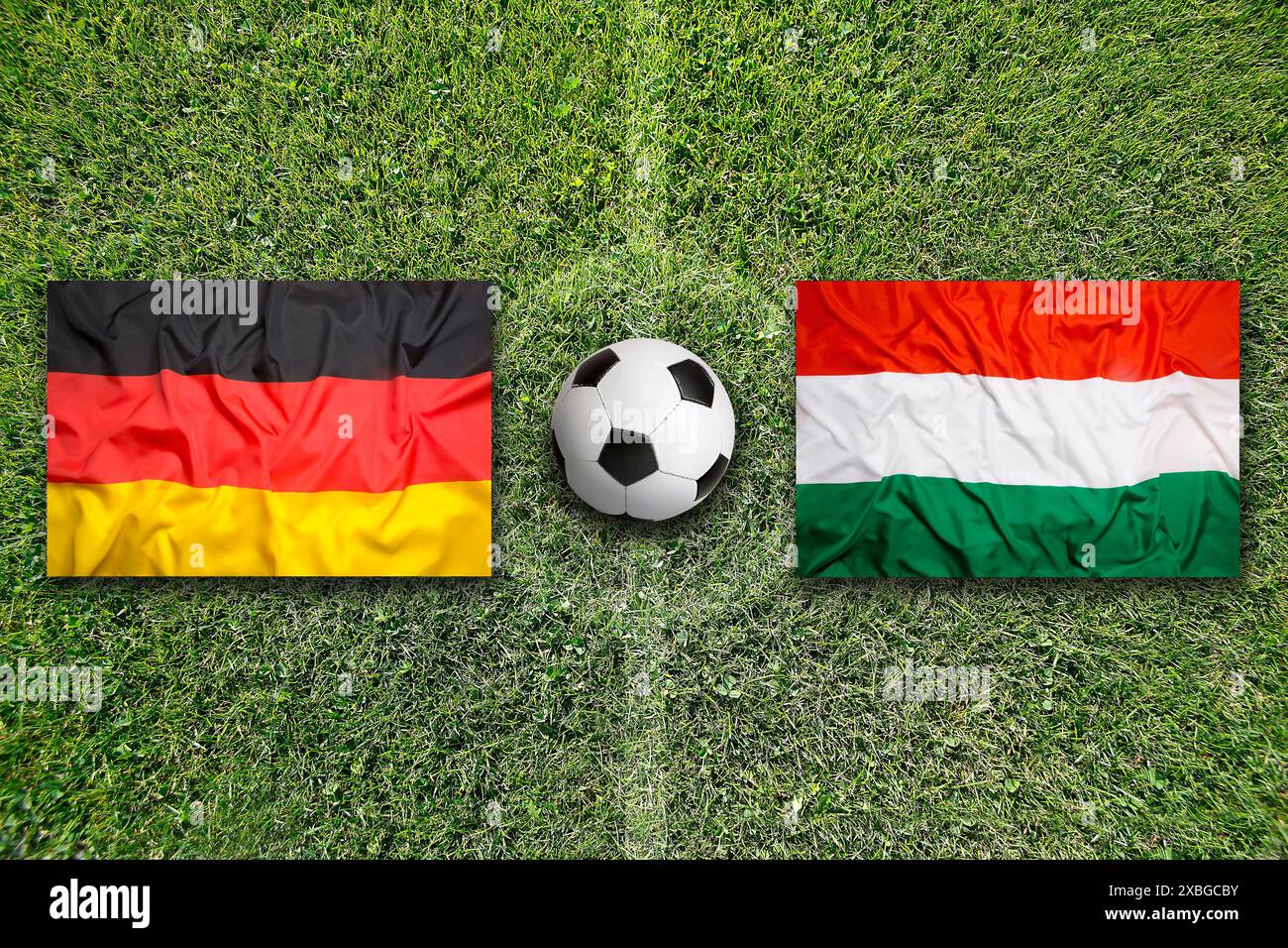 Germany vs. Hungary flags on green soccer field Stock Photo - Alamy