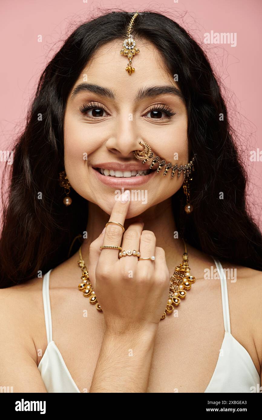 Beautiful indian woman with long hair and gold jewelry striking a pose ...