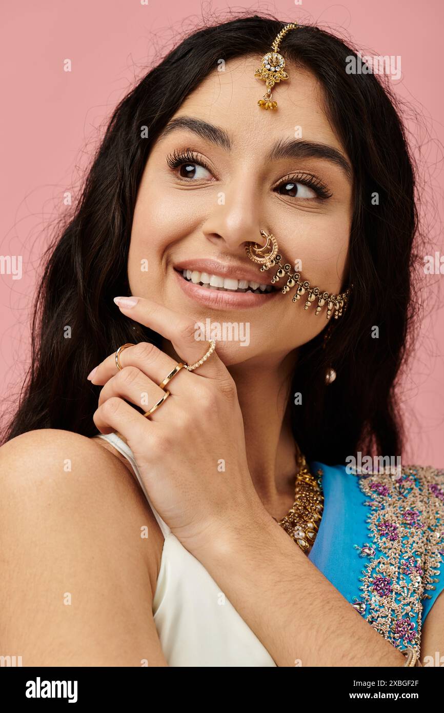 A beautiful young indian woman gracefully poses in a stunning blue and ...