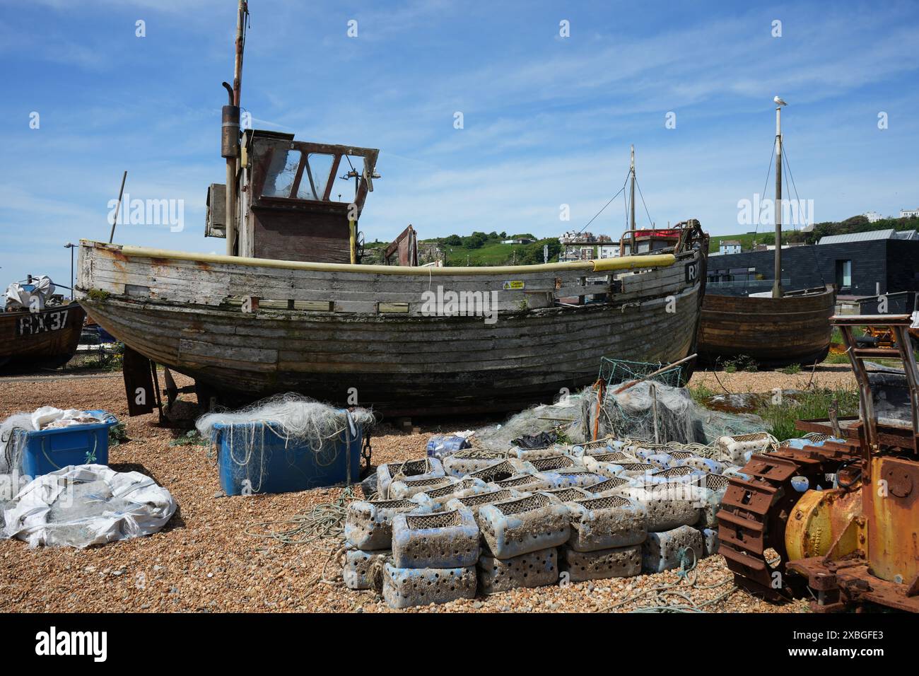 Rustic wooden fishing boat on the shingle beach with fishing ...