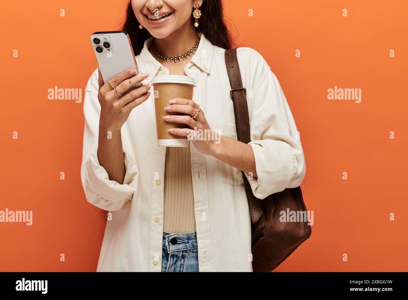 indian woman multitasking with coffee and phone in hand Stock Photo - Alamy
