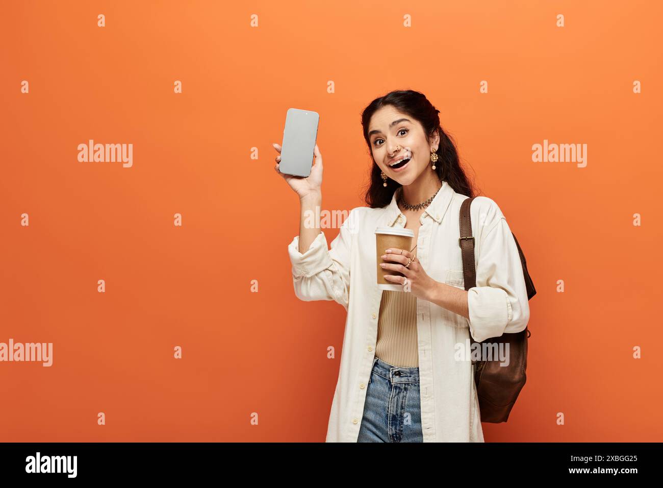 Young indian woman multitasking with phone and coffee cup Stock Photo ...