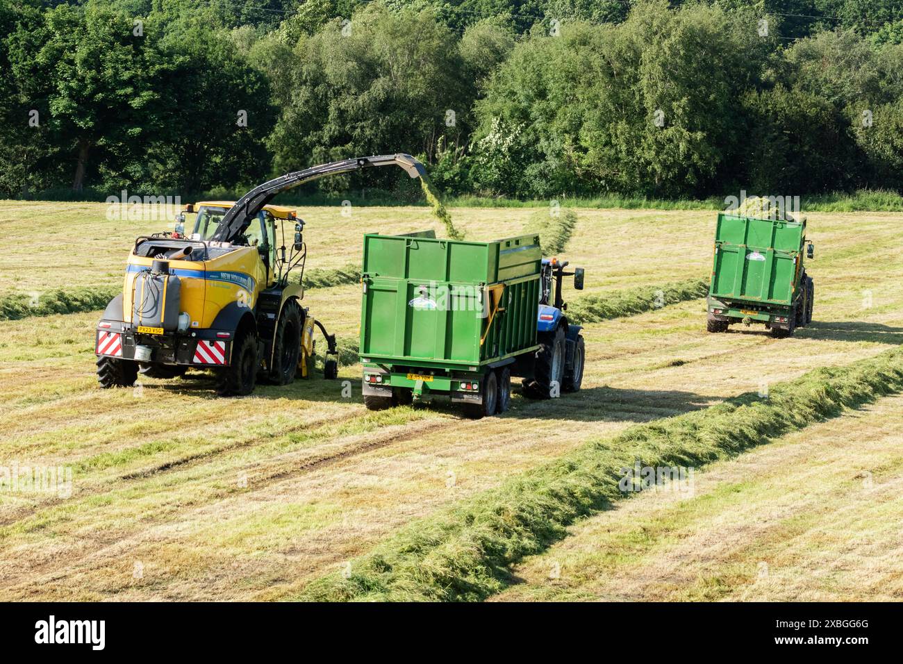 Farm machinery at work collecting grass for silage in Baildon ...