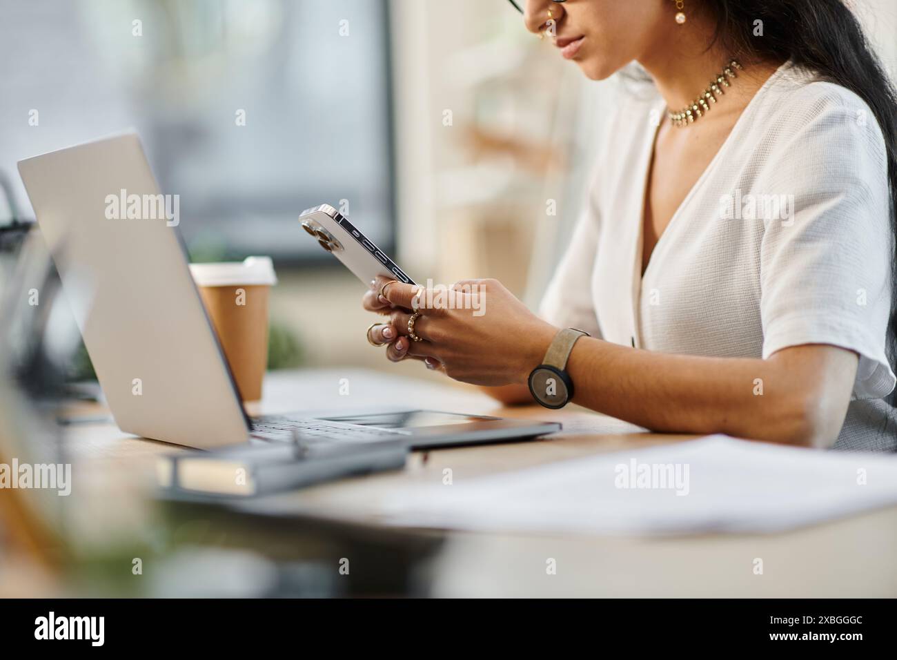 A young indian woman using phone at desk Stock Photo - Alamy