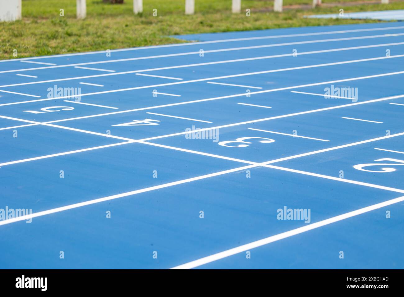 finish line on a blue running track, highlighting the lane numbers ...