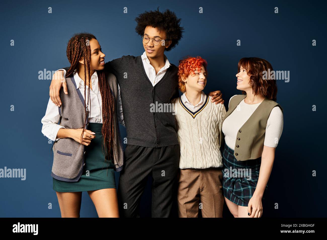 Multicultural friends, stand together in stylish attire on a dark blue ...