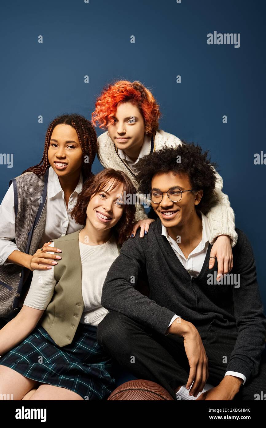 A group of young friends, sitting together in stylish attire on a dark ...
