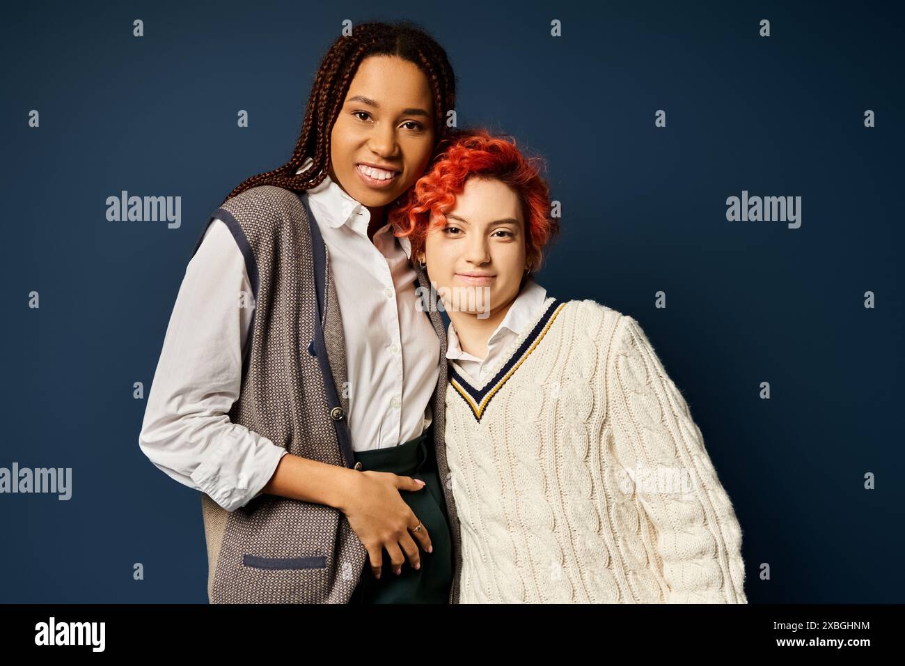 Two young multicultural friends, including a nonbinary person, stand ...