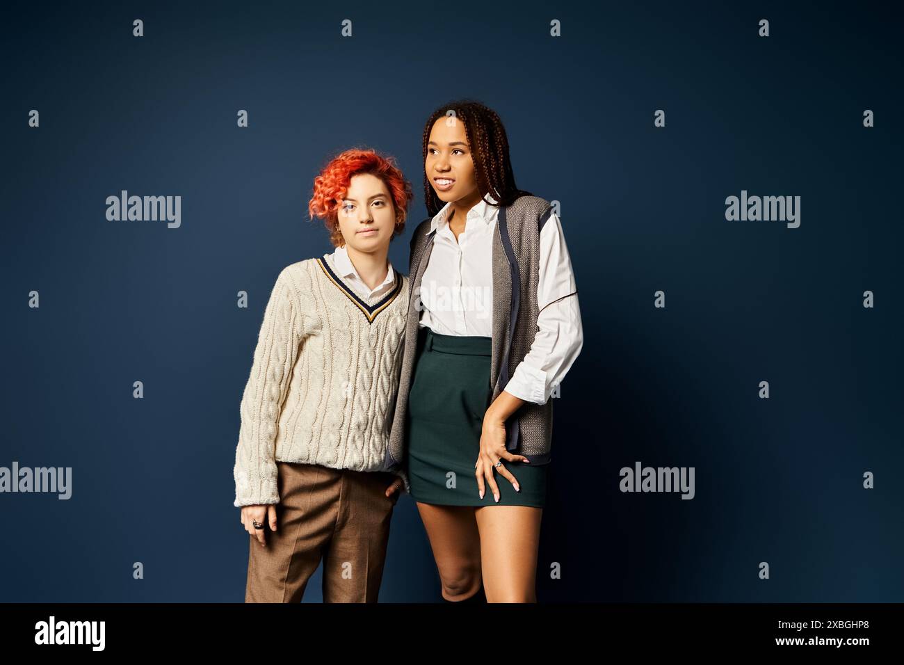 Young multicultural friends, stand together in stylish attire on a dark ...