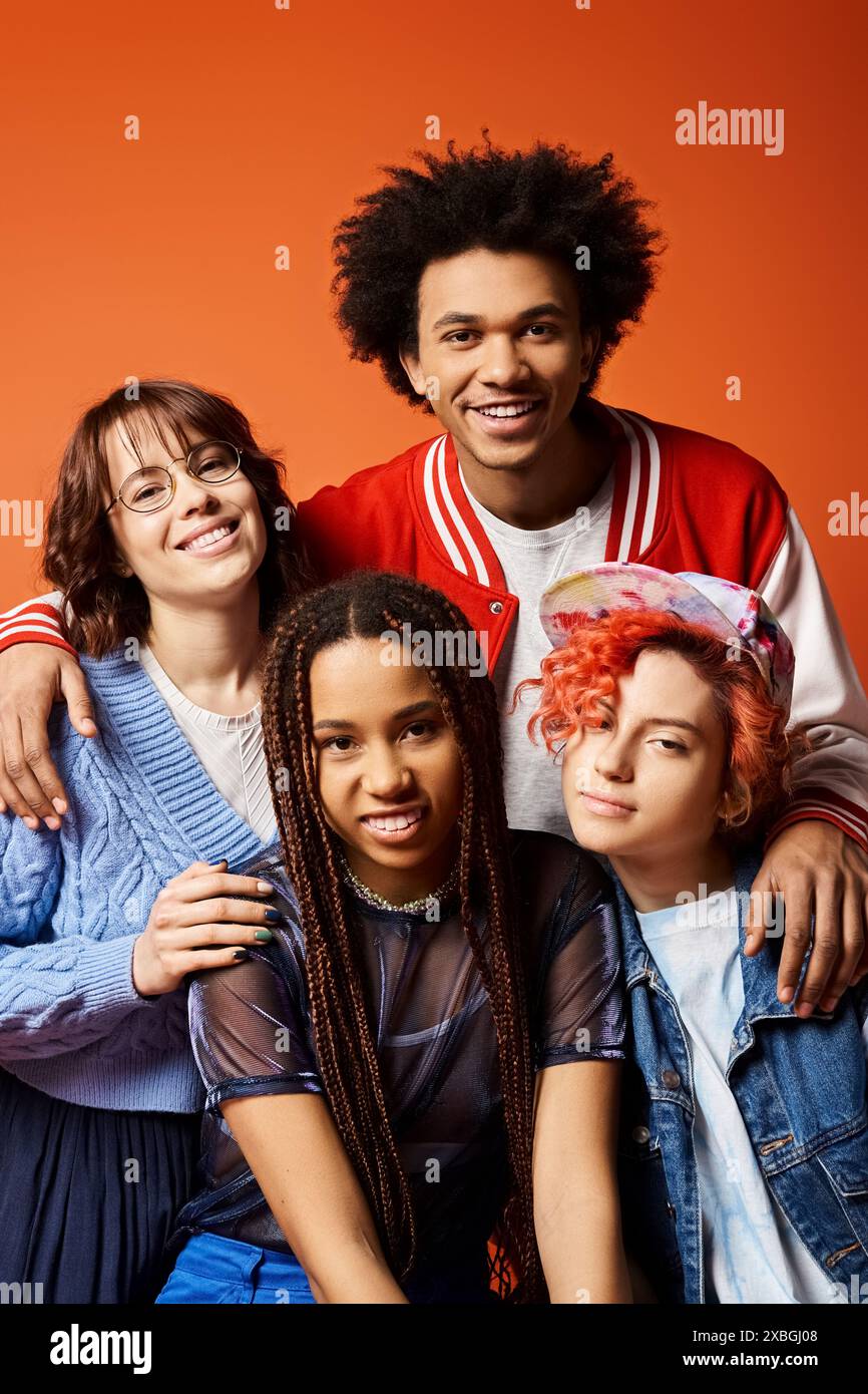 interracial group of young friends, including nonbinary person, posing ...