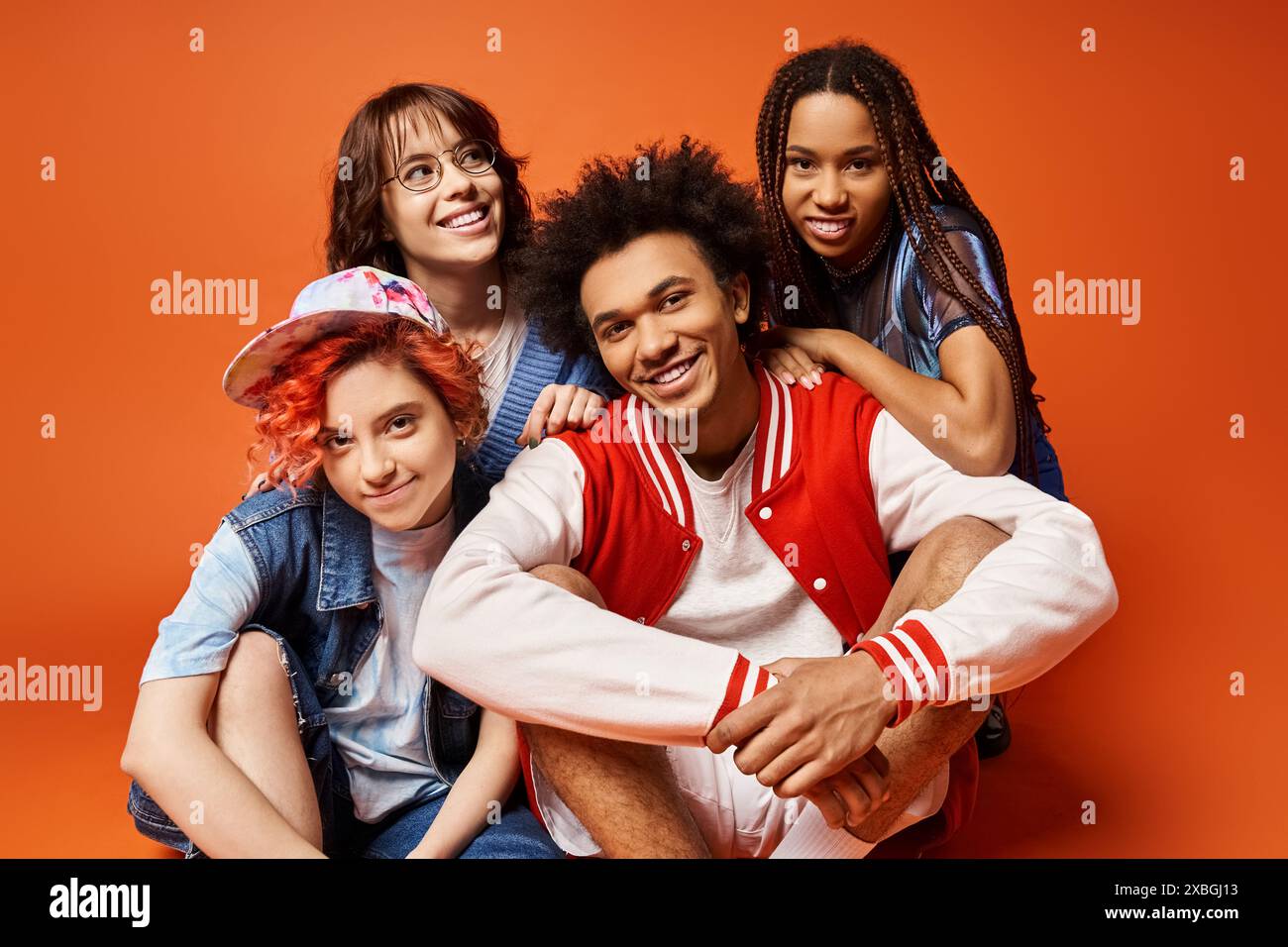 Young diverse friends, including nonbinary person, standing together in ...