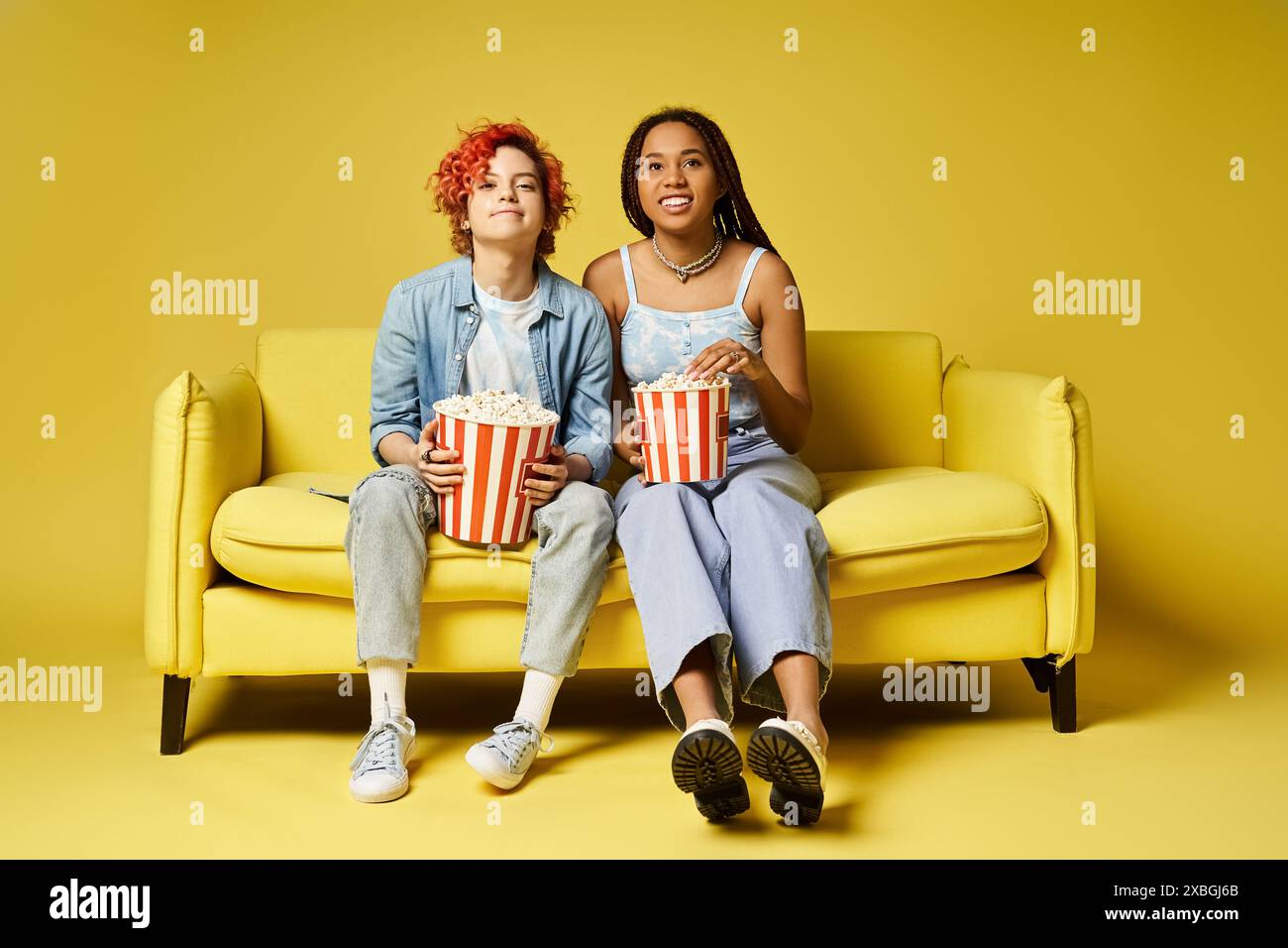 friends relax on a cozy couch, each holding a bucket of popcorn ...