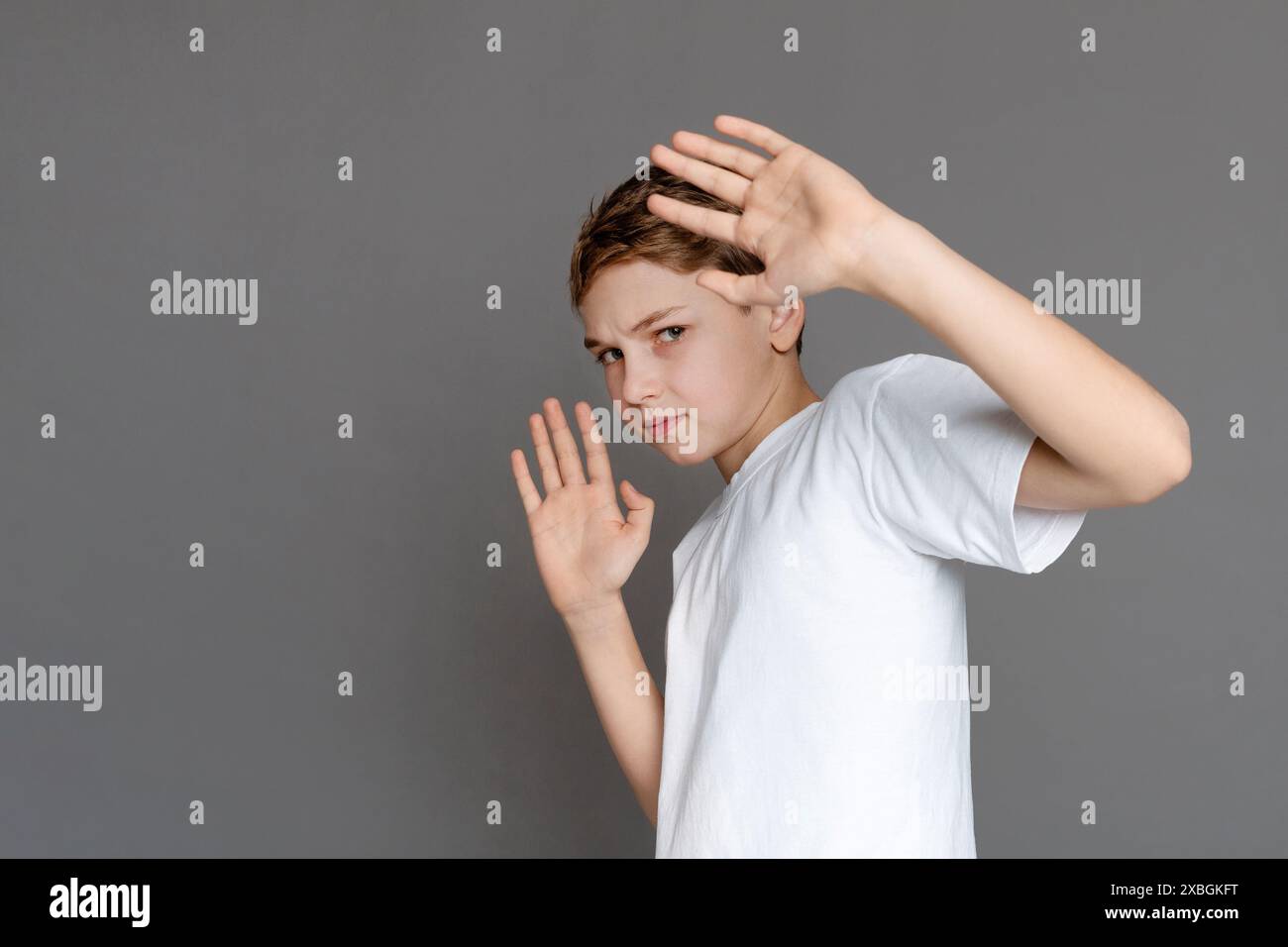 Teen boy making stop gesture with hands Stock Photo - Alamy