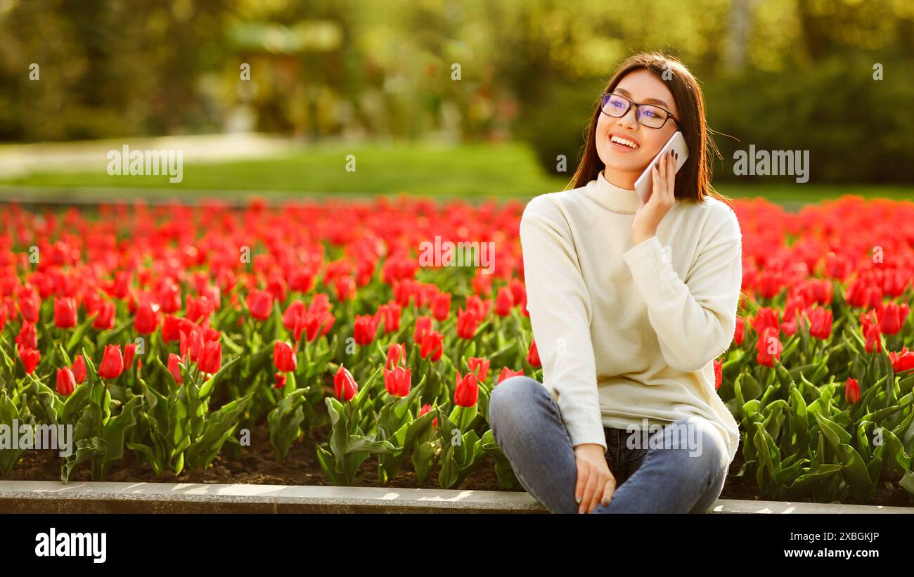 Korean Woman Sitting on Bench Talking on Cell Phone Stock Photo - Alamy