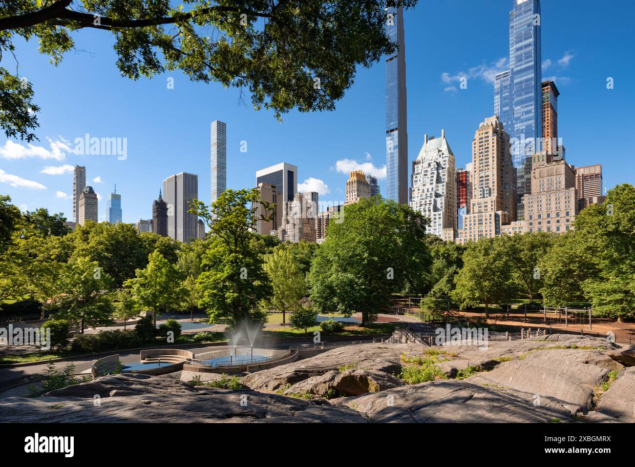 Summer Morning in Central Park with granite rock formations and view of ...
