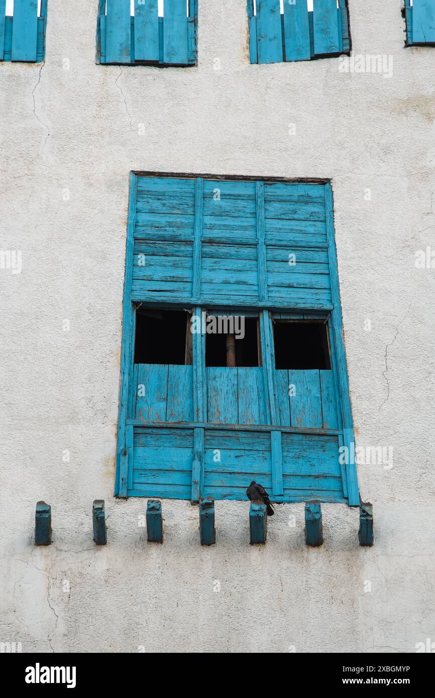 Jeddah, Saudi Arabia - December 12, 2022: A weathered blue shuttered ...