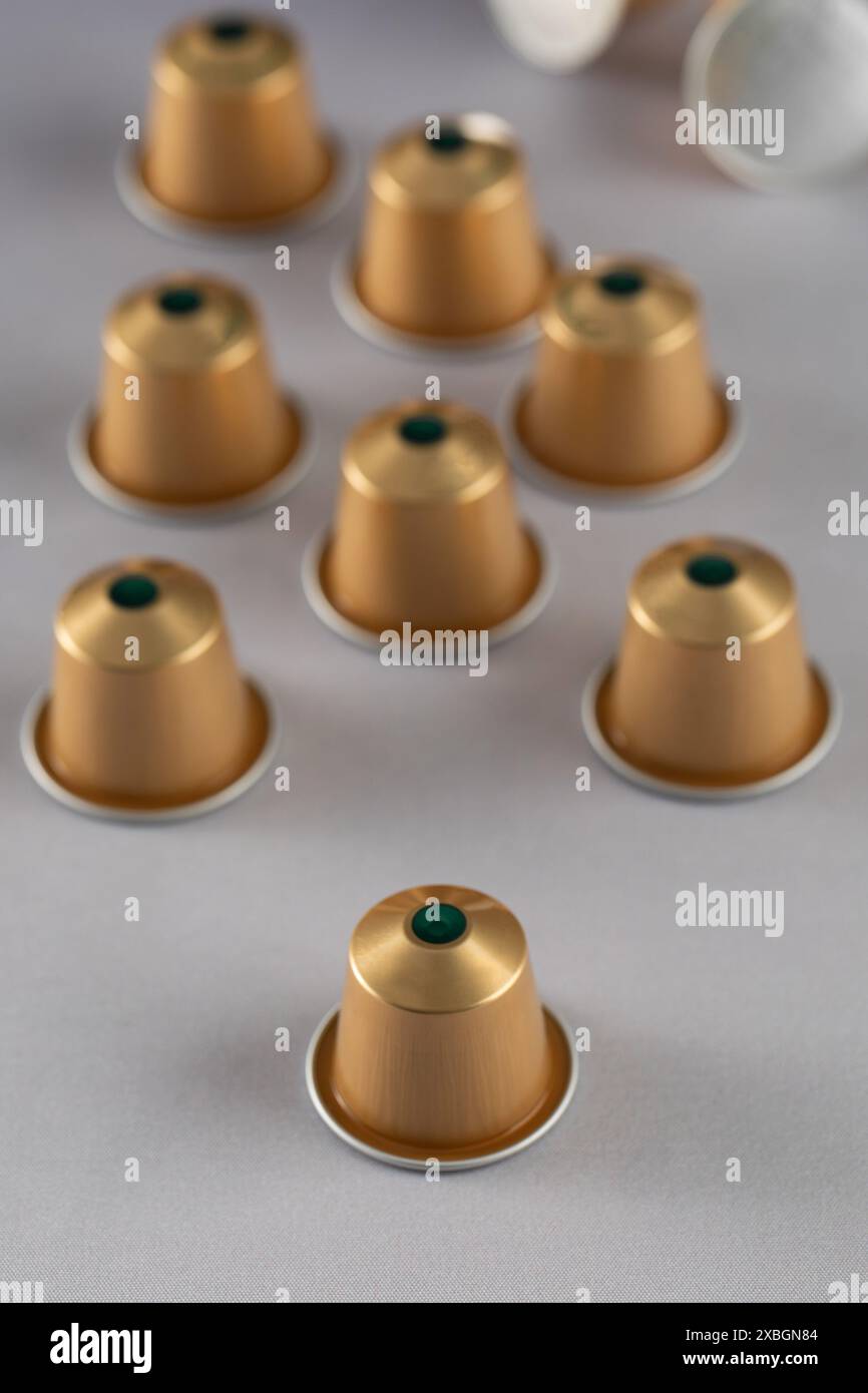gold coffee capsules arranged on a neutral background, modern design ...