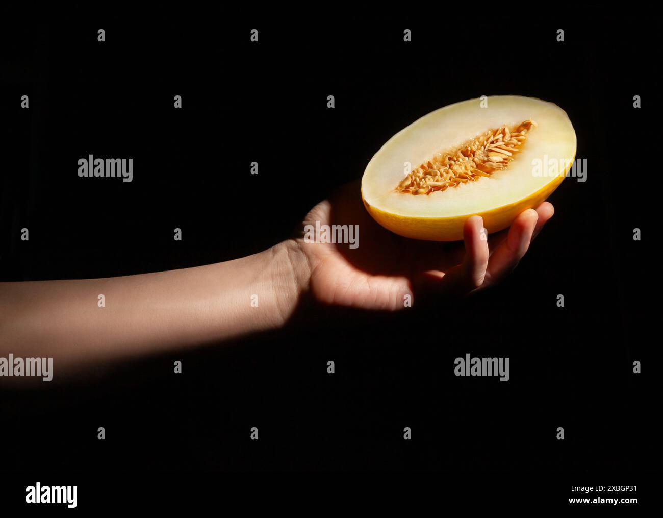 Hand holding melon hi-res stock photography and images - Alamy