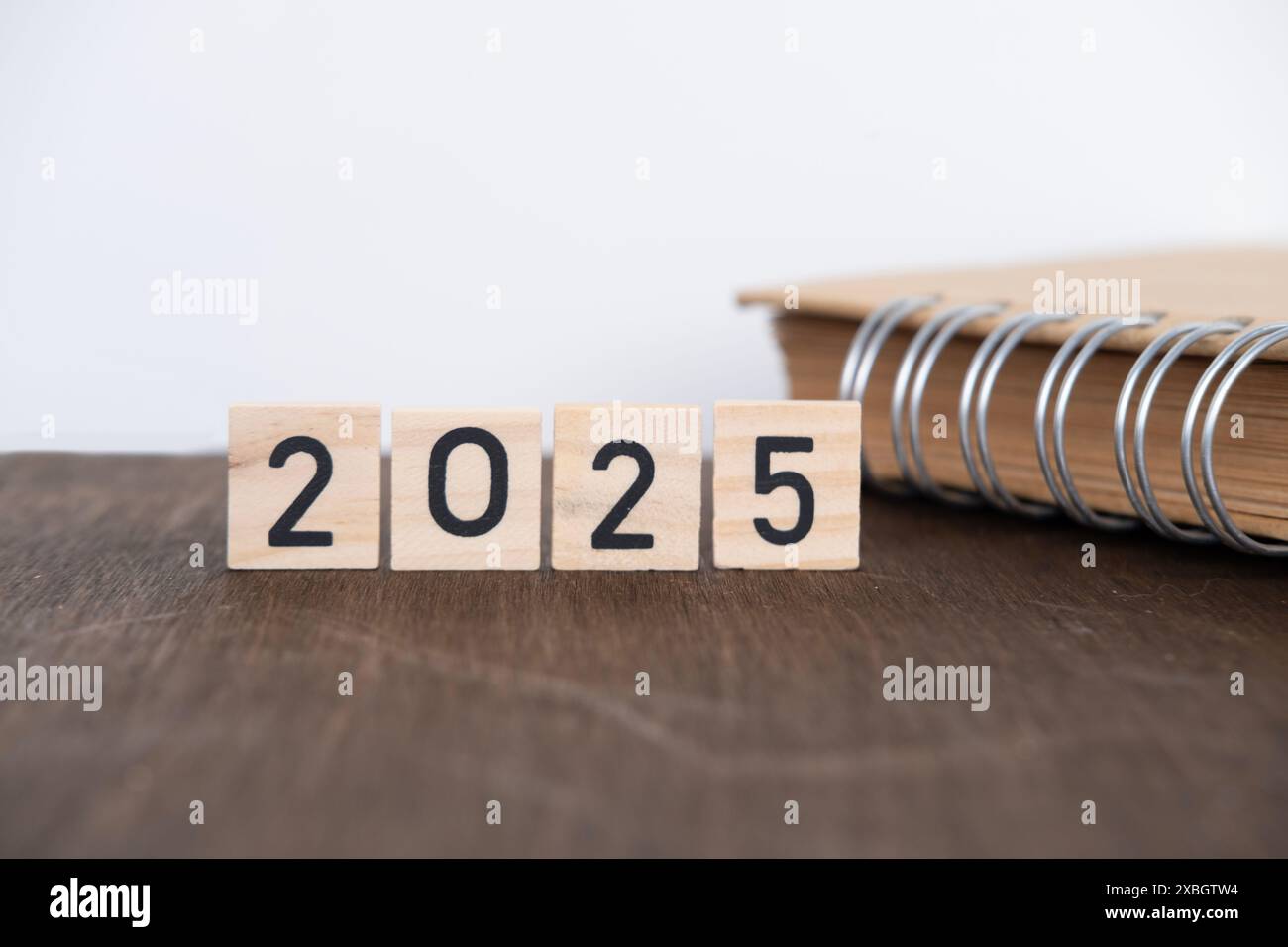 Wooden letters spelling date 2025, notebook, daily planner on vintage ...