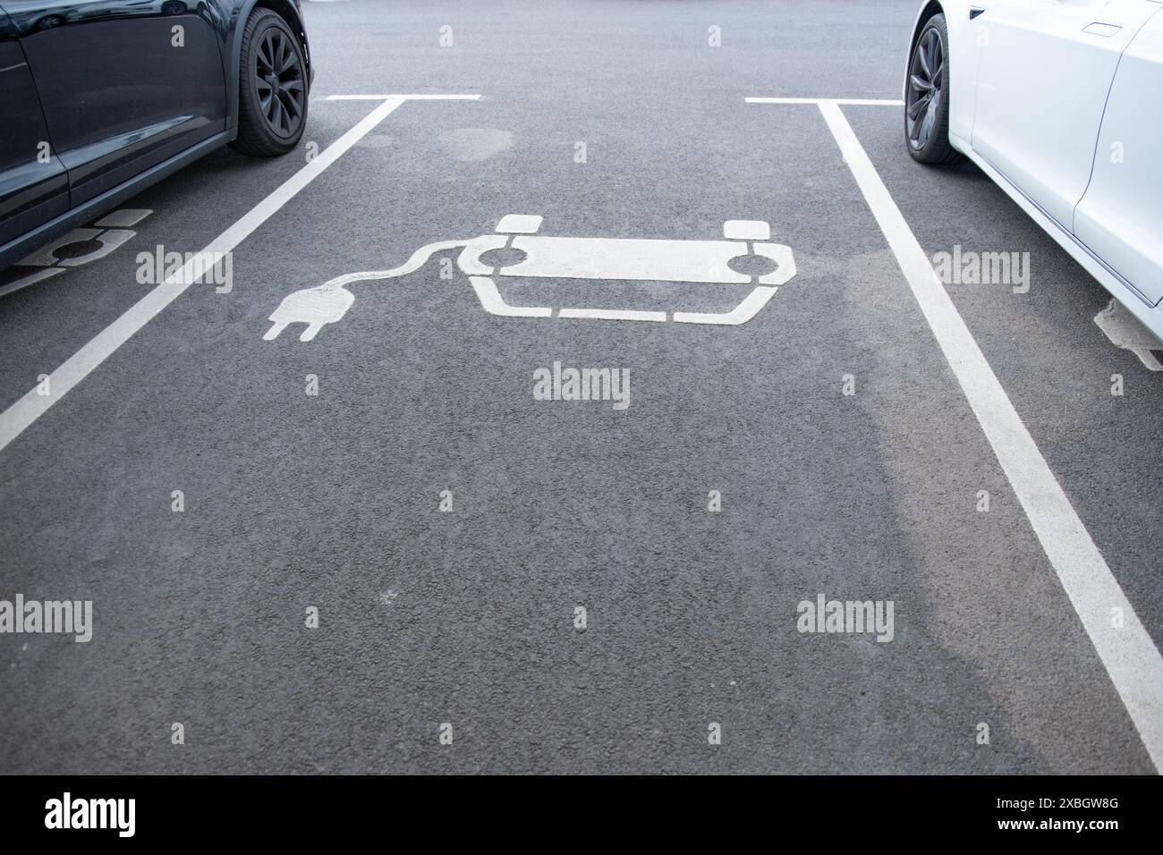white electric vehicle sign painted on asphalt, charging station, Power ...