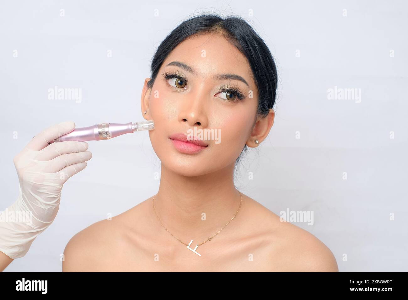 Elegant Asian Woman Applying Dermatology Pen for Skincare Routine at ...