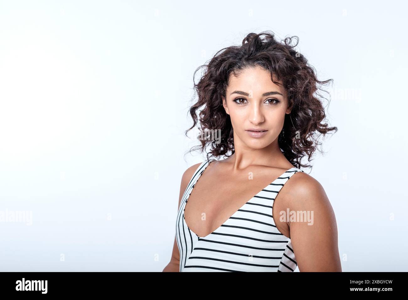 An enigmatic confident young mediterranean womanin half profile looks ...