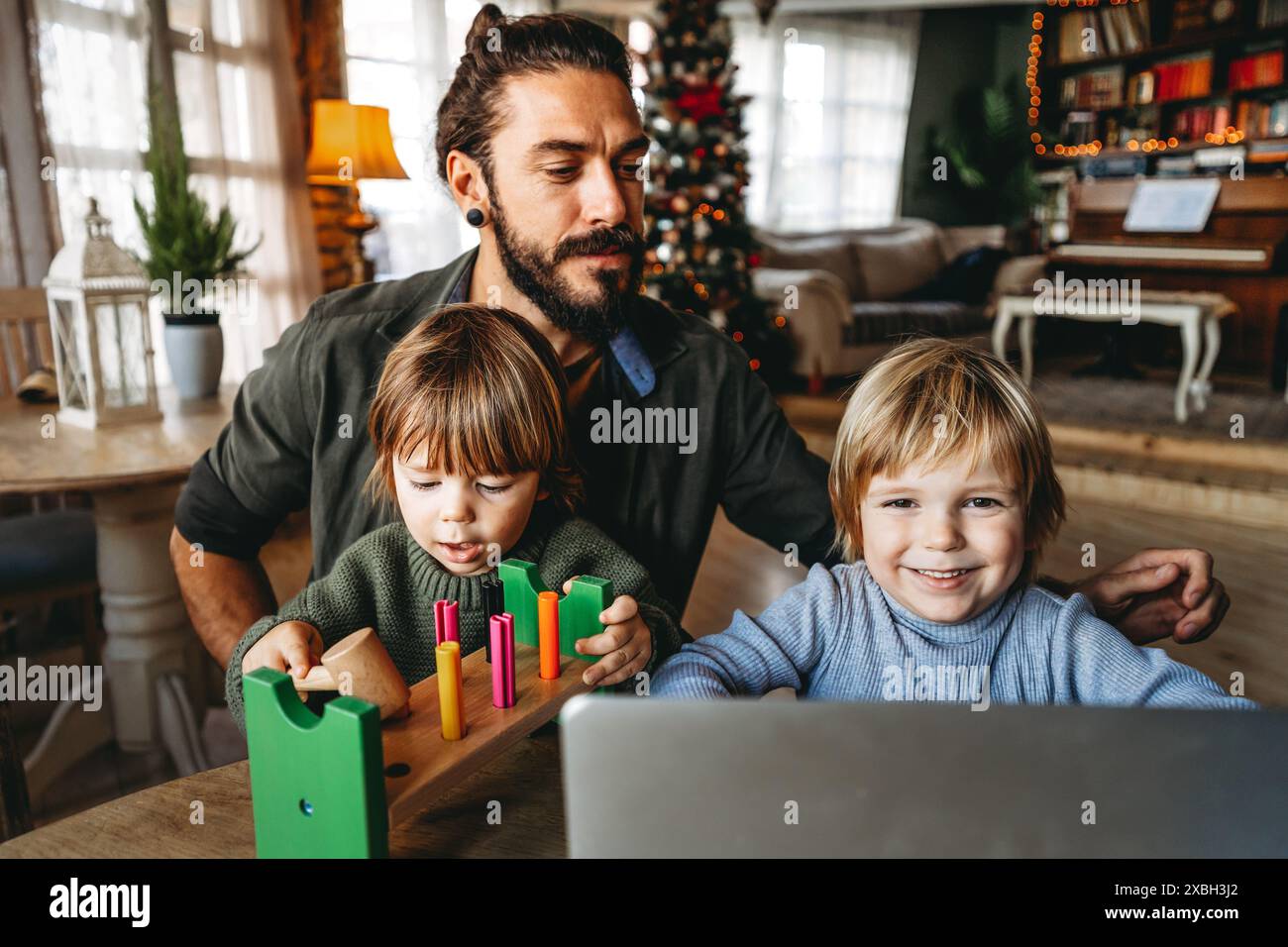 Multi-tasking freelance and fatherhood concept. Working single father ...