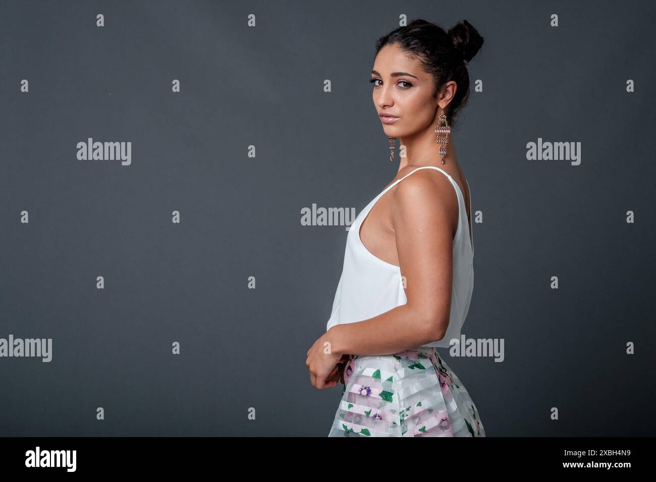 Beautiful woman in her 20s wearing summer fashions in a studio fashion ...