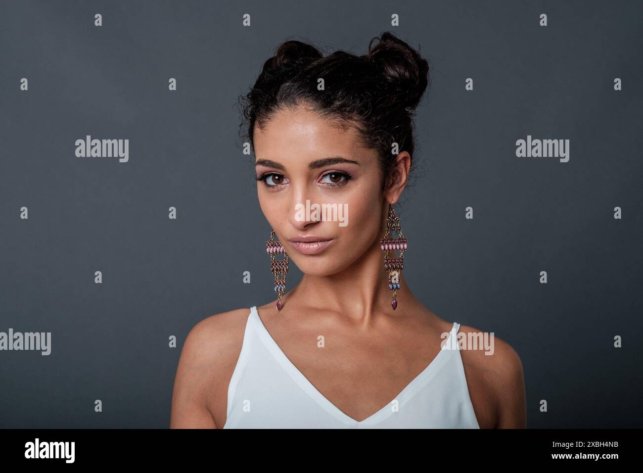Beautiful woman in her 20s wearing summer fashions in a studio fashion ...