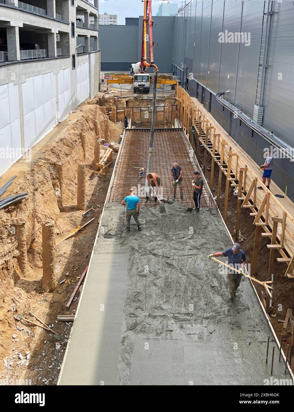 Construction workers pouring foundation. Construction and crew work ...
