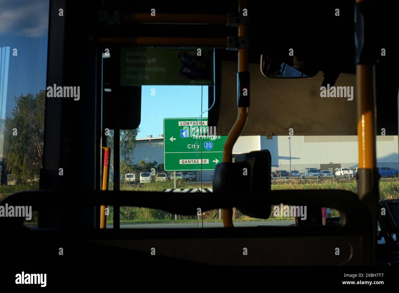 View of a large green road sign, directions to QANTAS Drive, through ...