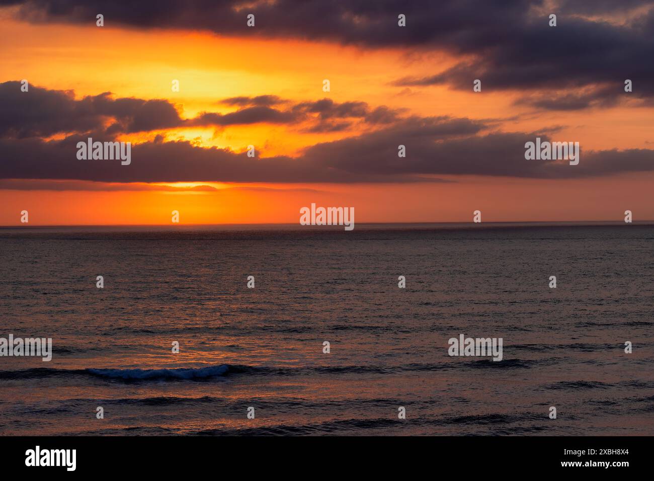 Sun rising in cloudy skies over the Atlantic Ocean at Nags Head, in ...