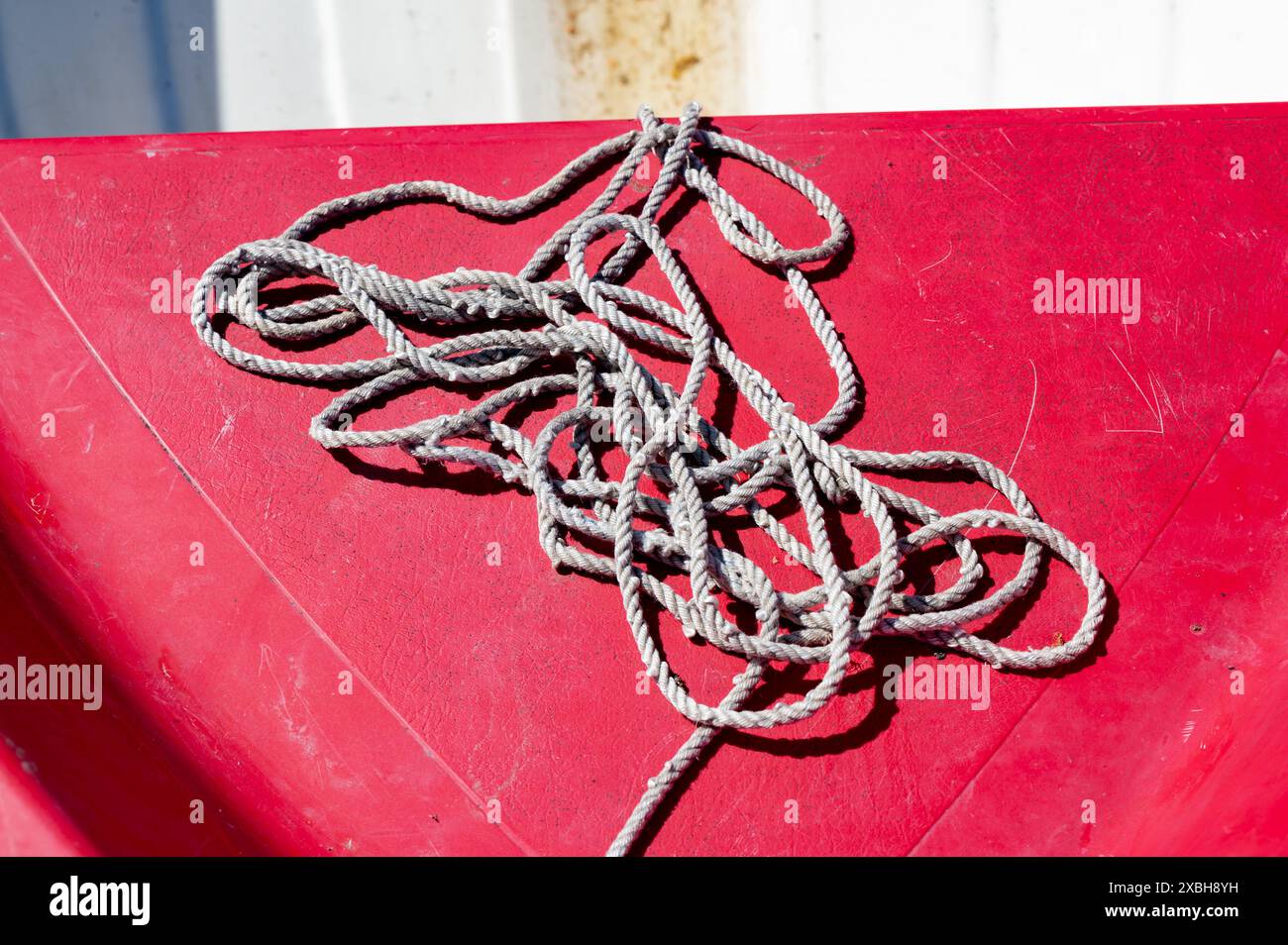 Tangled rope lying on plastic boat a sunny day Stock Photo - Alamy